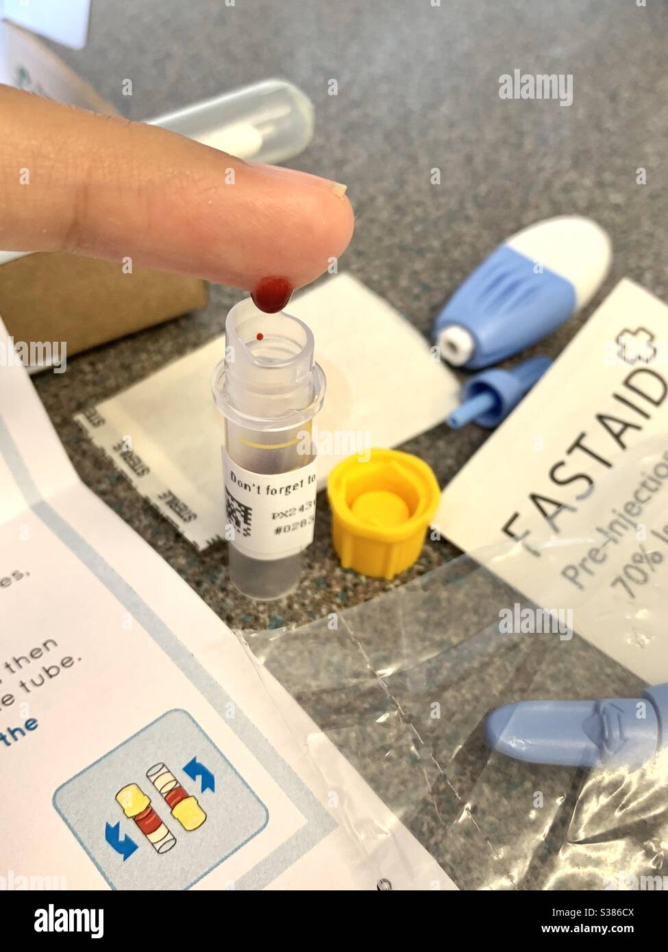 Collecting a sample of blood for NHS test kit Stock Photo - Alamy