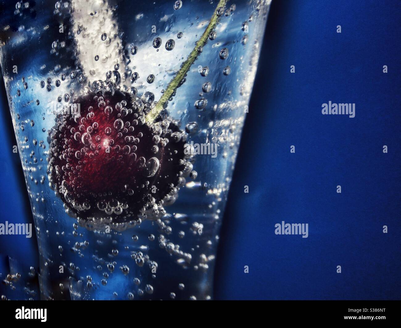 Macro Photography - Cherry in fizzy water Stock Photo - Alamy