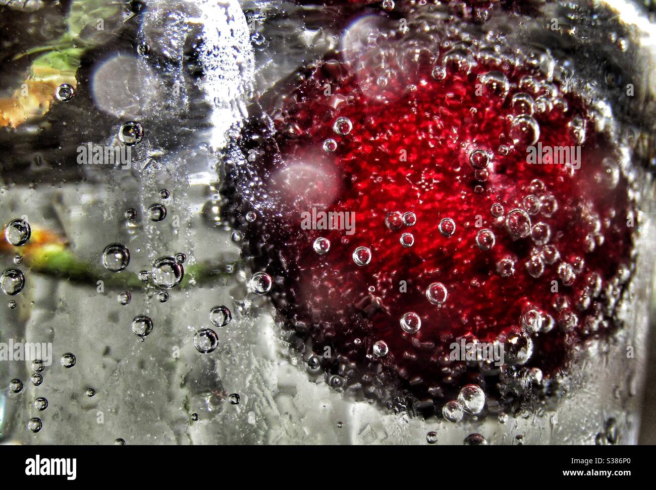 Macro photography - cherry in fizzy water Stock Photo - Alamy