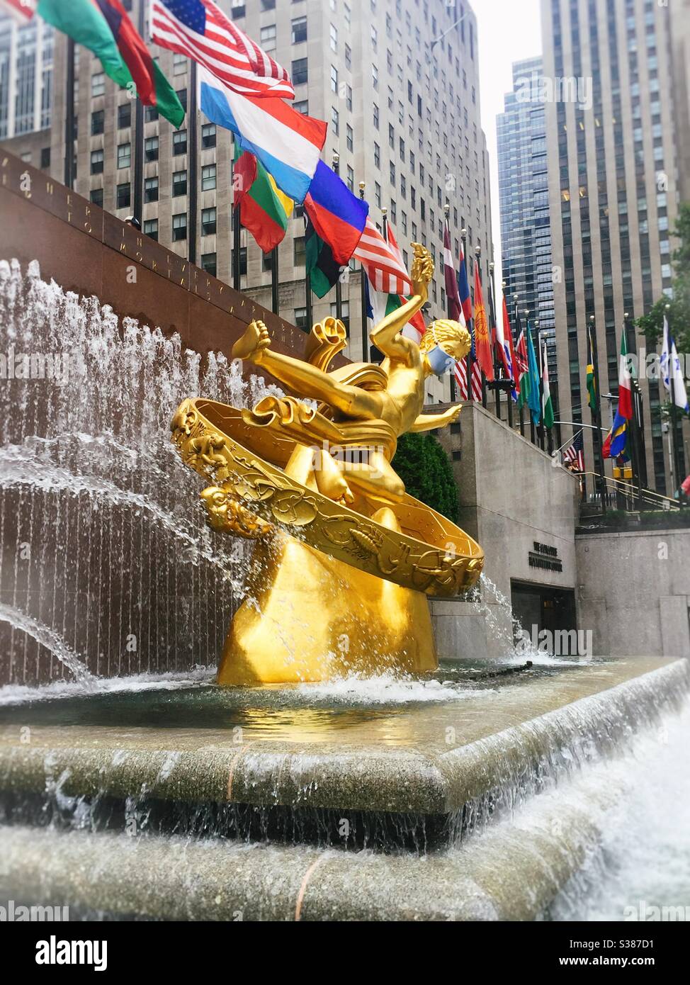 The huge statue of Prometheus in Rockefeller Center wears a facemask to ...