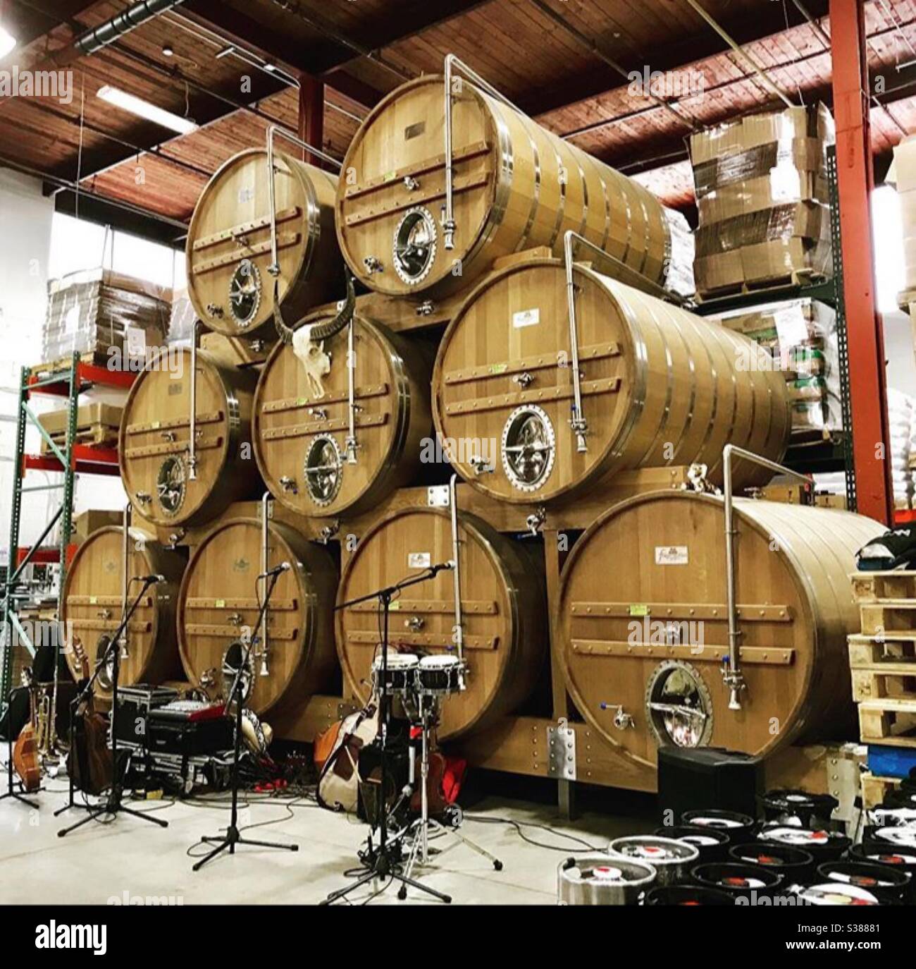 Craft beer barrels with a band setup in a brewery Stock Photo - Alamy