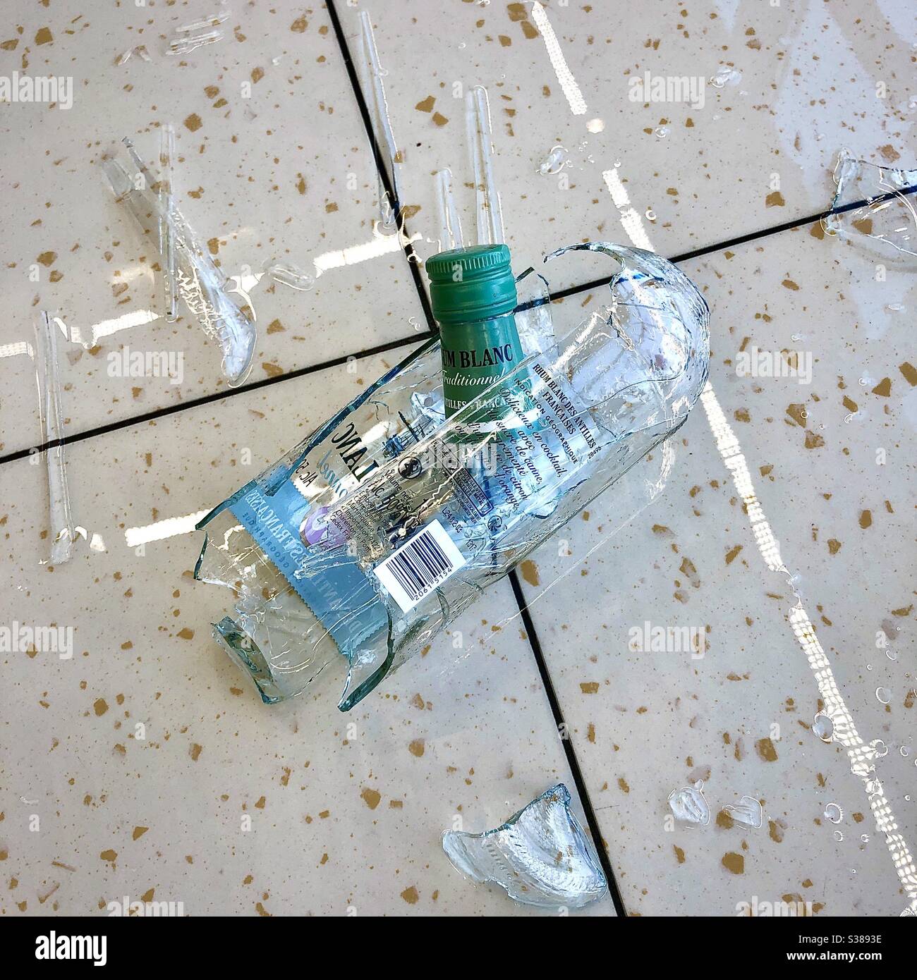 Smashed bottle of white rum on supermarket floor Stock Photo - Alamy
