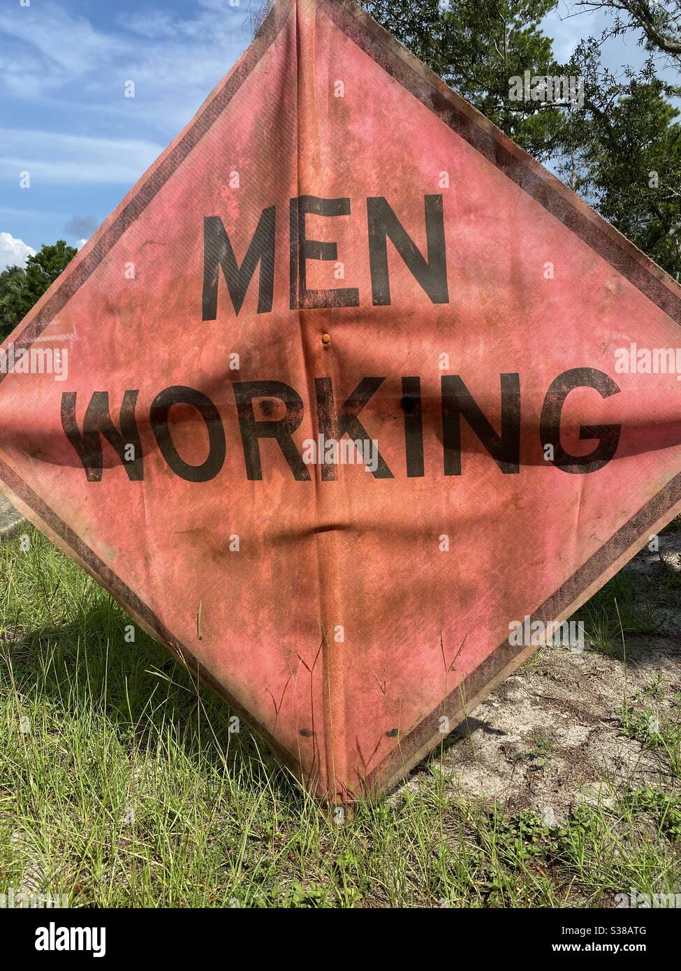 Large red men working sign Stock Photo - Alamy
