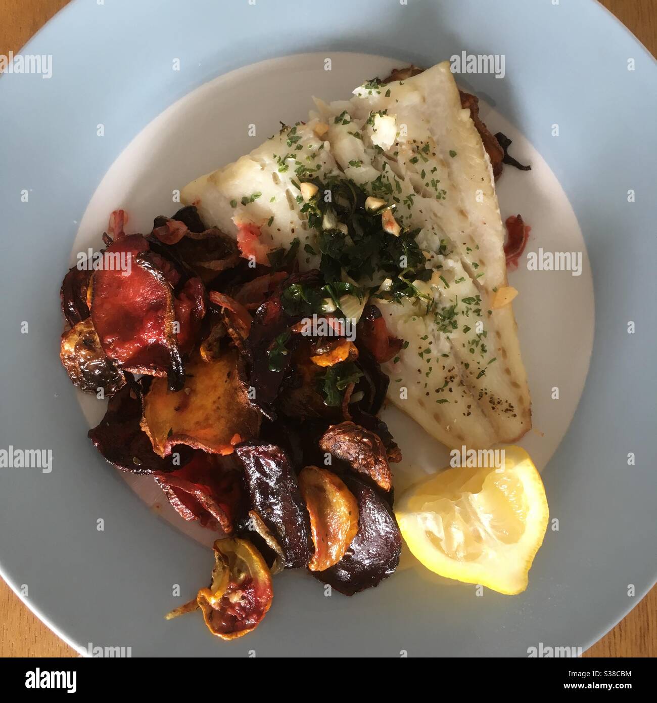 White fish and crispy roasted root veg Stock Photo - Alamy