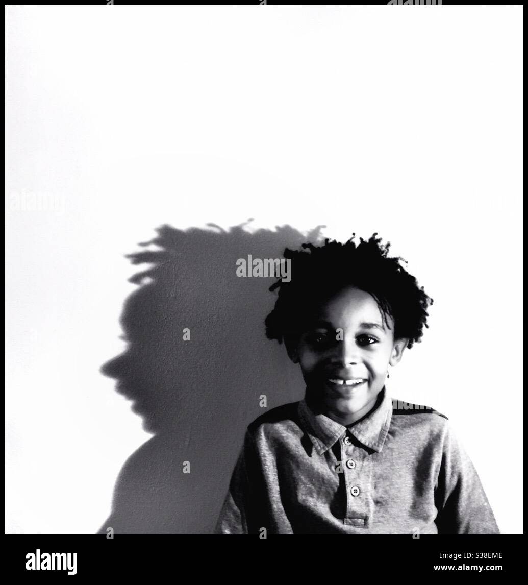A laughing boy and his shadow Stock Photo - Alamy