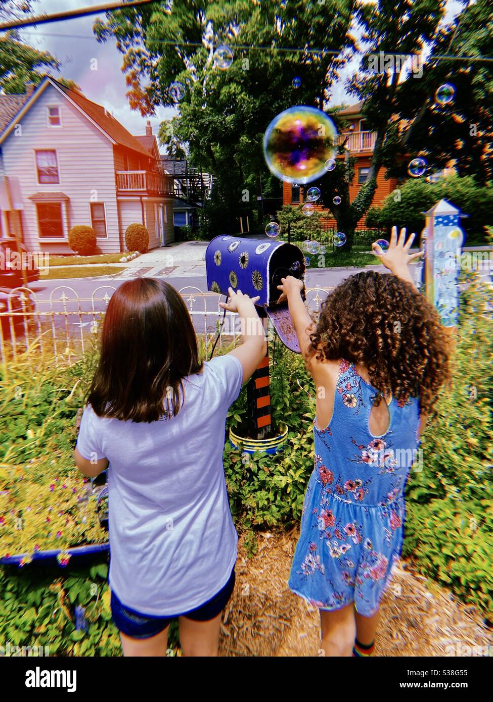 Little girls catching bubbles Stock Photo - Alamy
