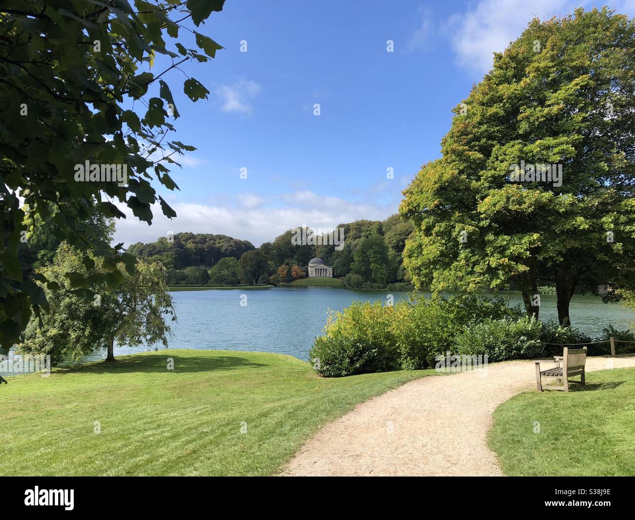 Path curves around by the lake at Stourhead Stock Photo - Alamy