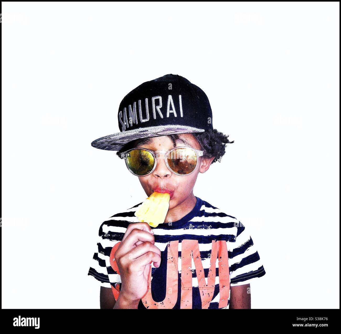 Cool kid sucking a lolly pop Stock Photo - Alamy