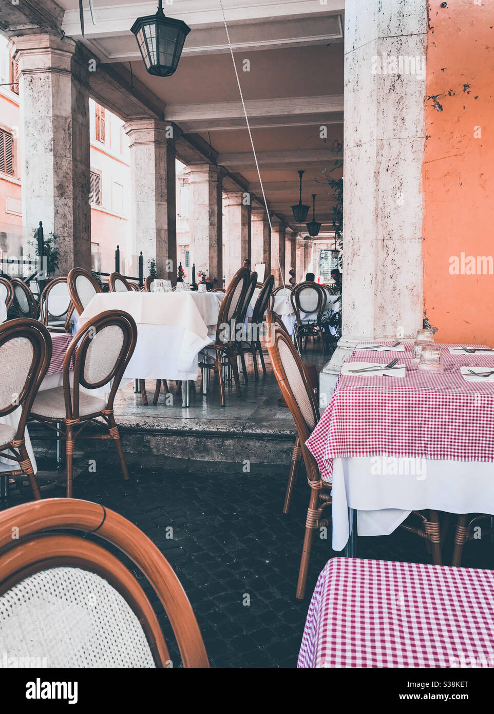 Empty al fresco tables at an Italian restaurant Stock Photo - Alamy