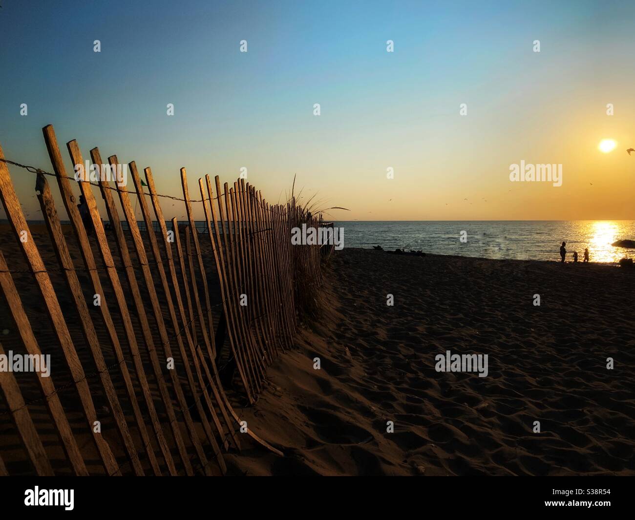 Sunset at Lake Michigan in summer with fence Stock Photo - Alamy