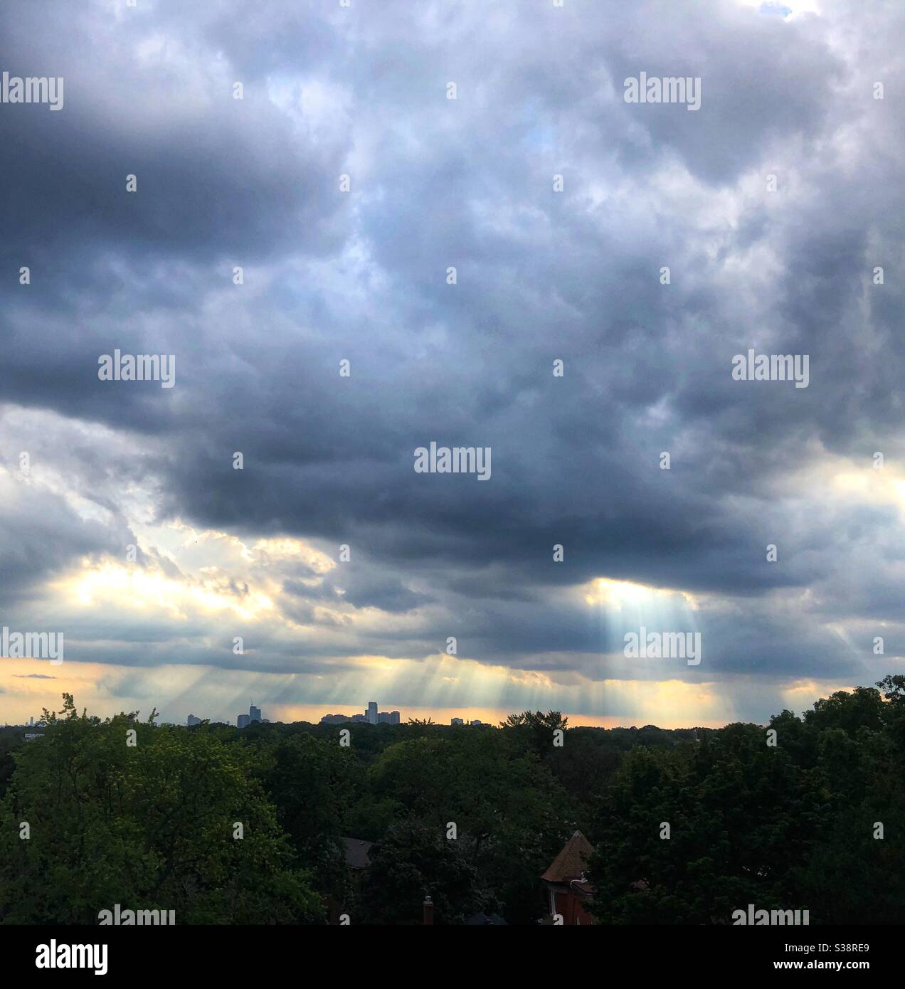 Sun rays streaming through the clouds Stock Photo - Alamy