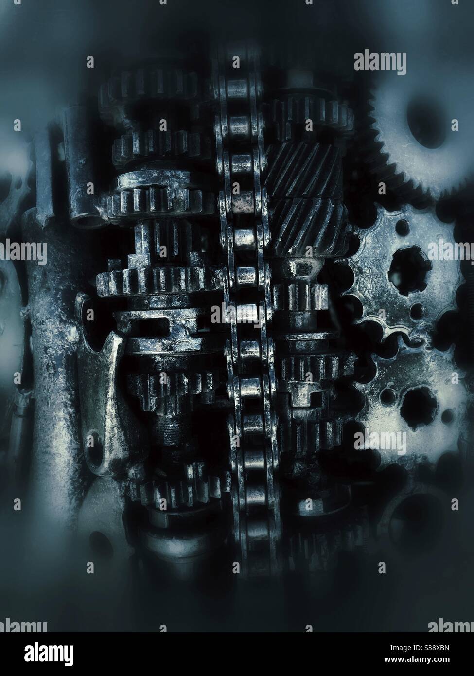 Selection of metal chains, cogs, wheels, nuts and bolts, desaturated ...