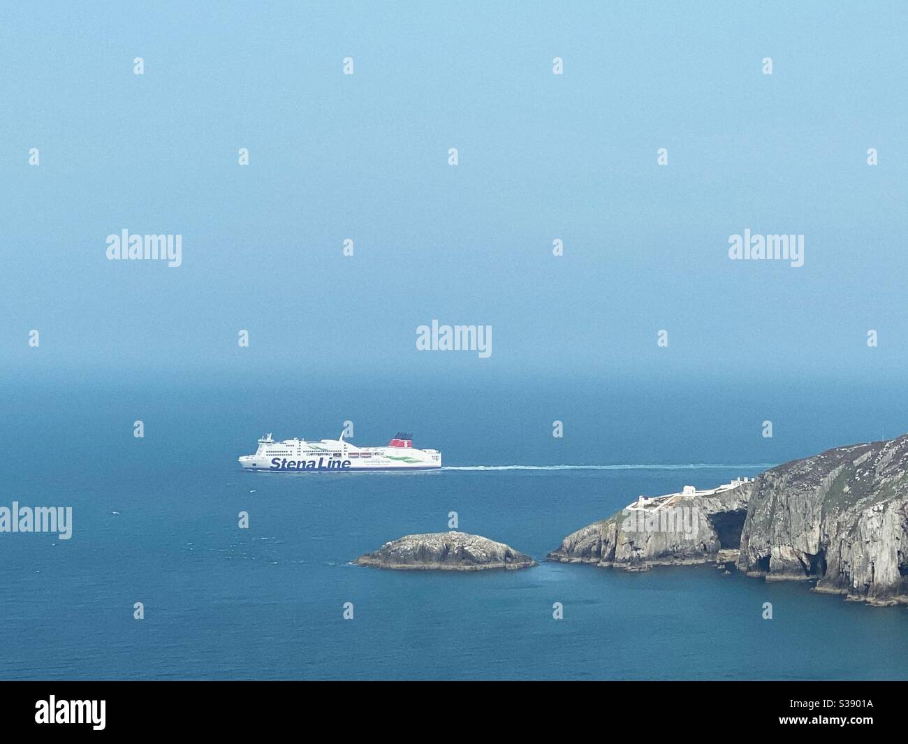 Passenger Ferry moving behind North Stack at Holyhead, Anglesey, North ...