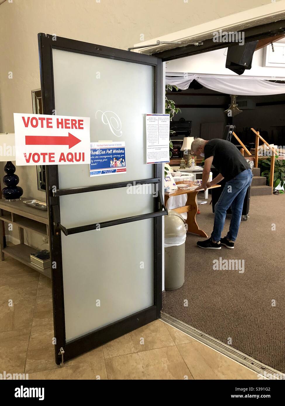 Voting at a community center with bilingual signs in English and ...