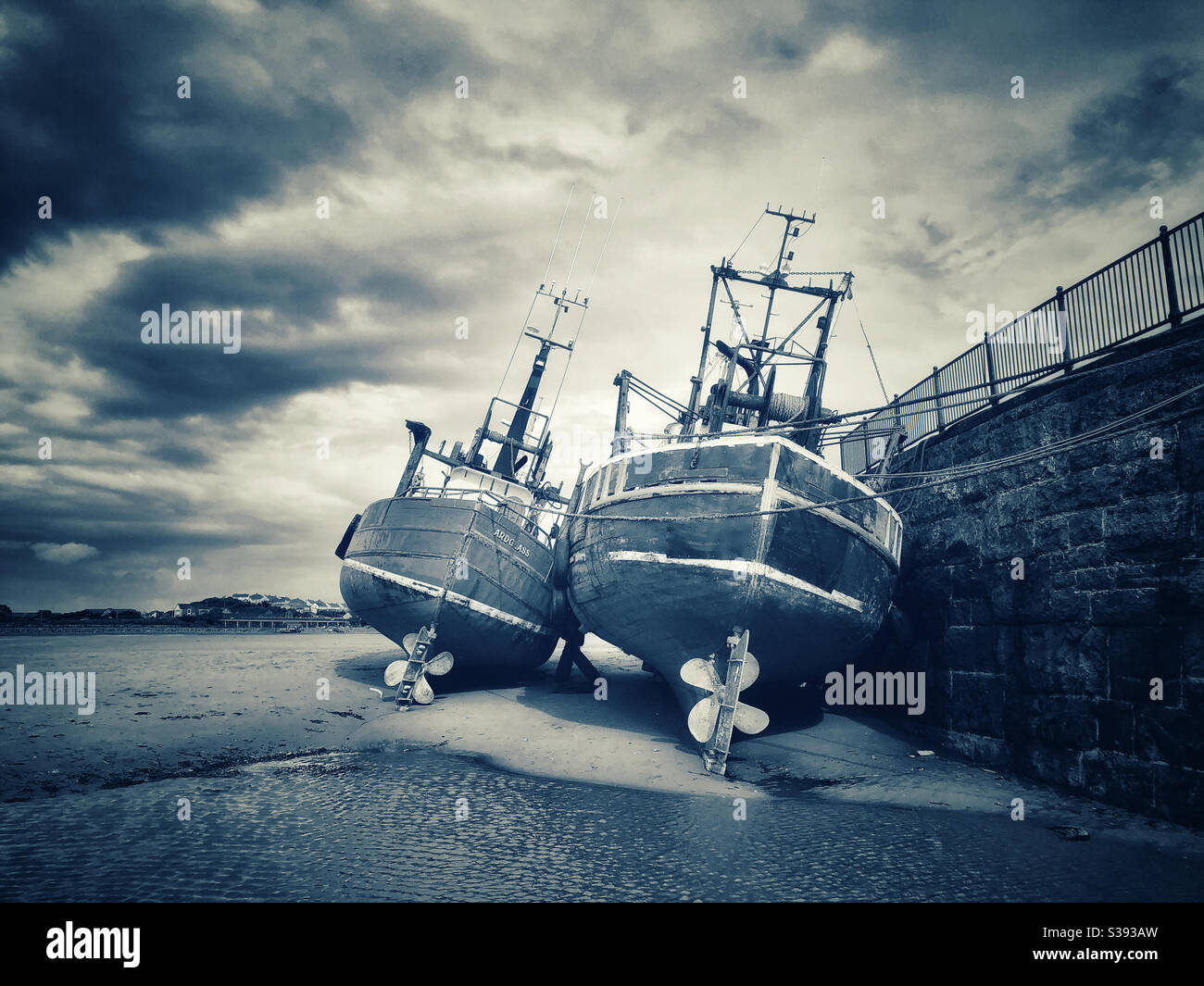 Two old trawlers beached against a harbour wall, Watchtower Bay, South ...