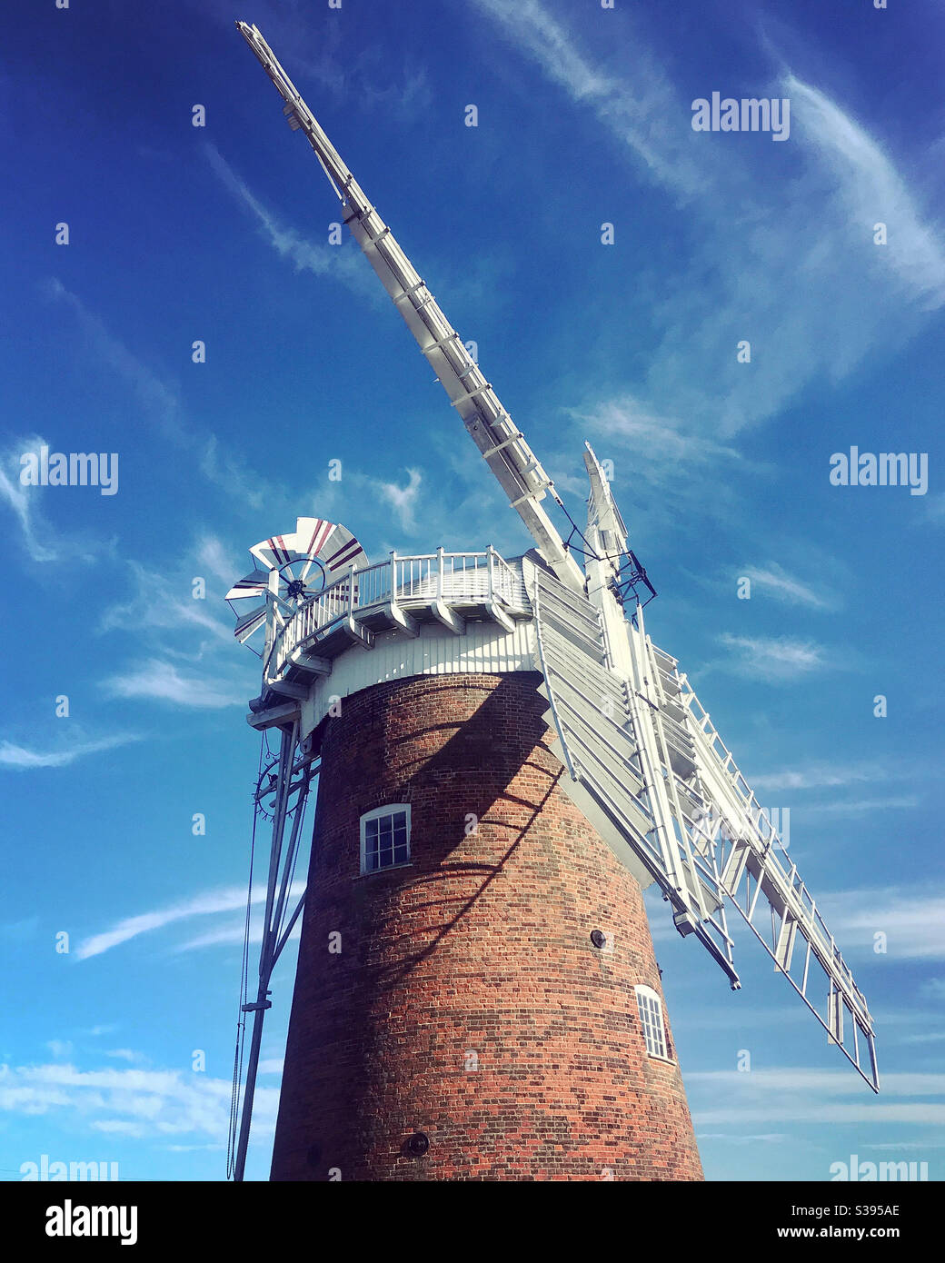 Windmill/wind pump made of bricks with beautiful blue sky and wispy ...