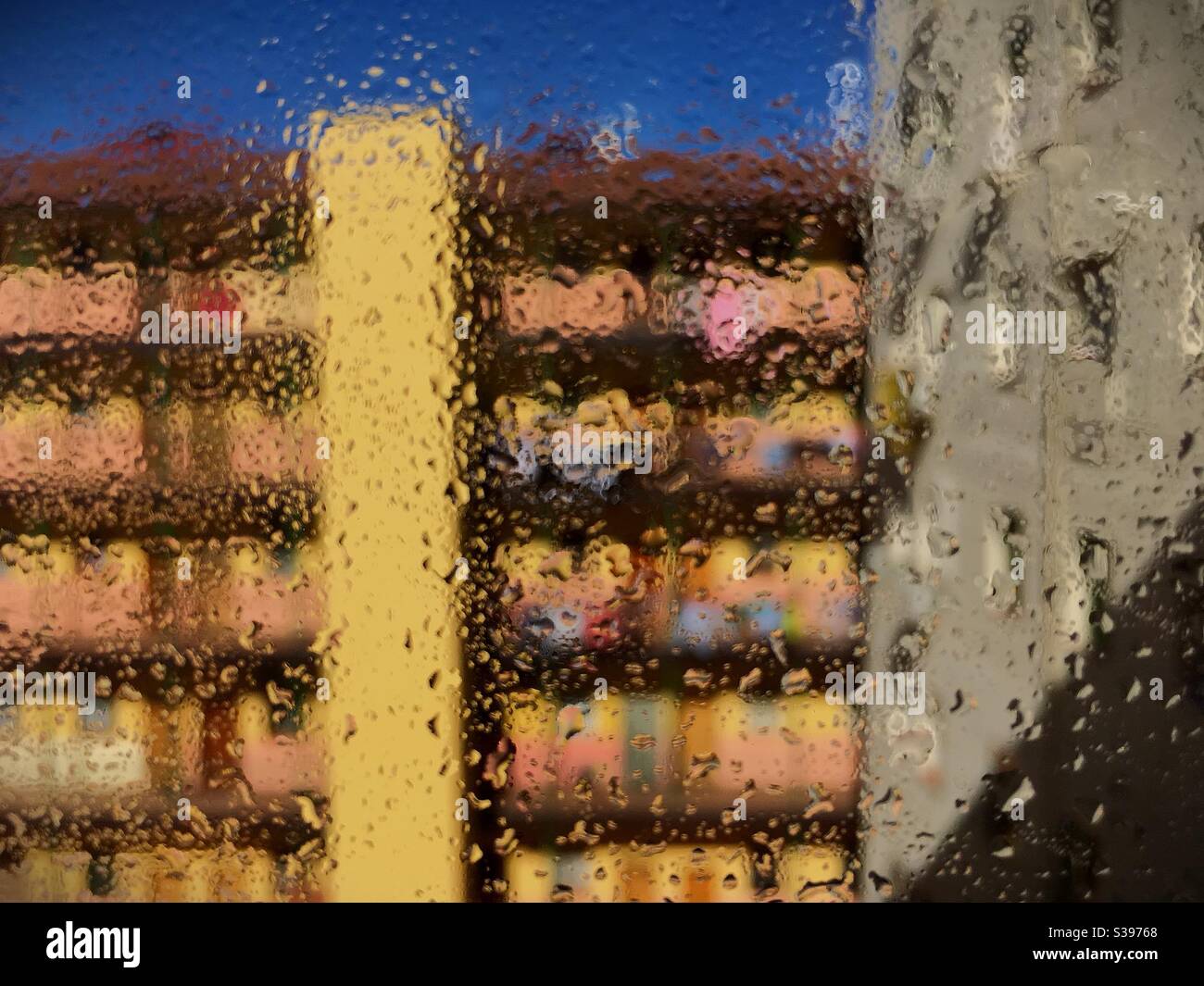 Colorful building through rainy window Stock Photo - Alamy