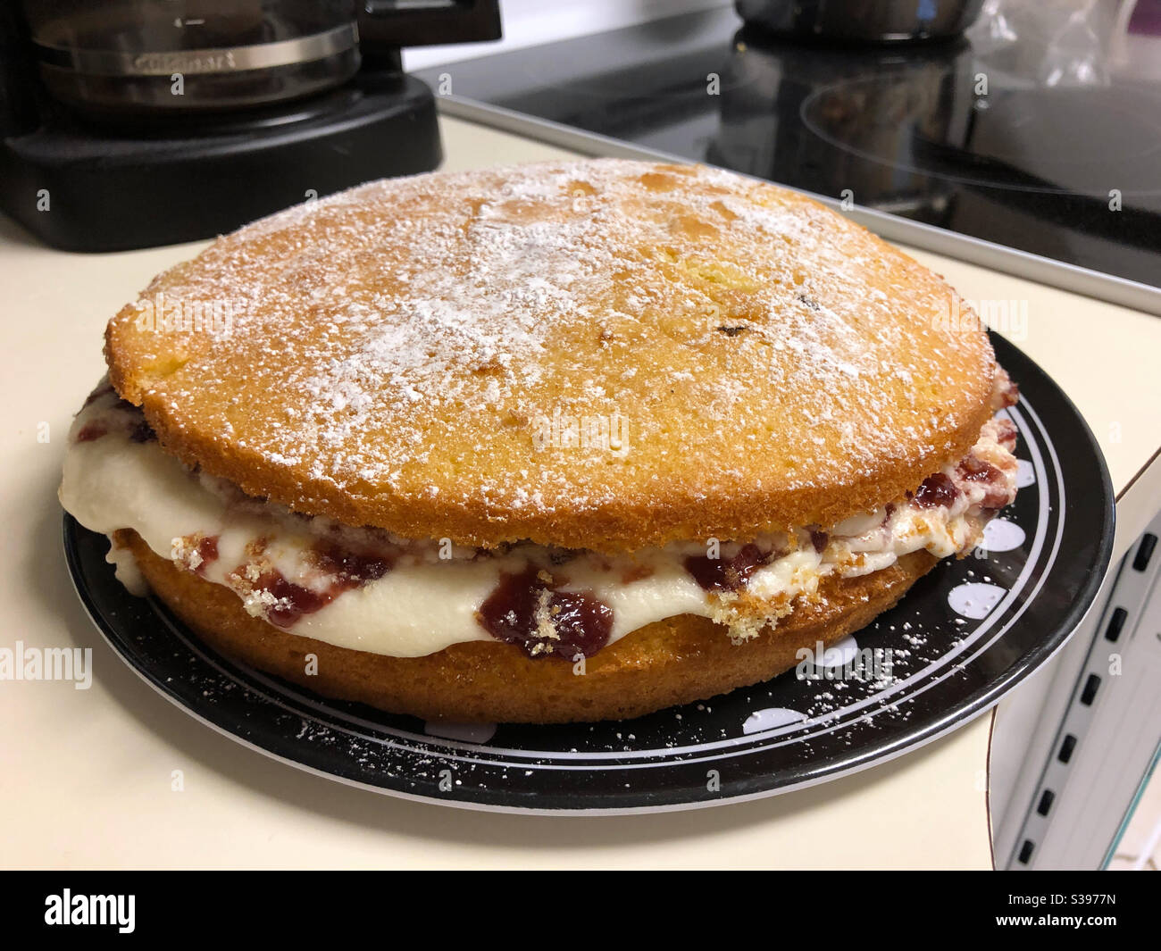 A Victoria sponge cake with buttercream and jam Stock Photo - Alamy