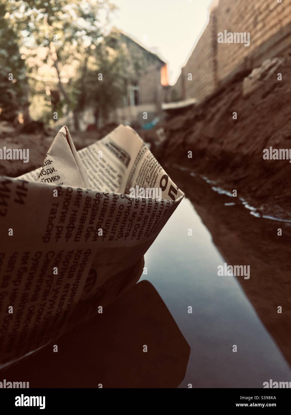 Newspaper boat on the water Stock Photo - Alamy