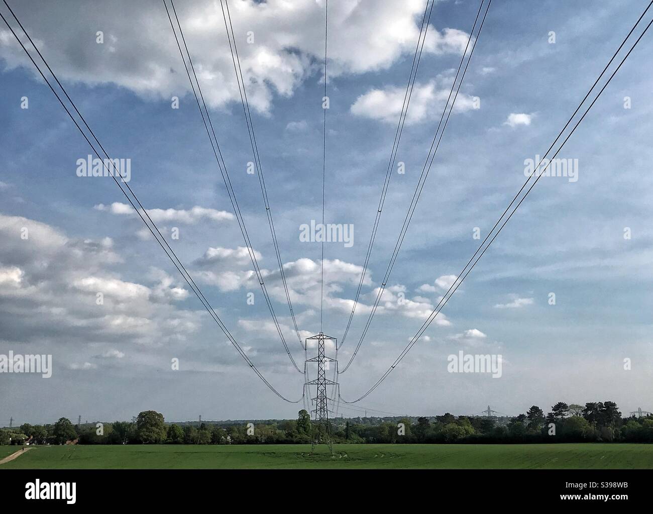 Pylon and electricity wires spreading across English UK countryside ...