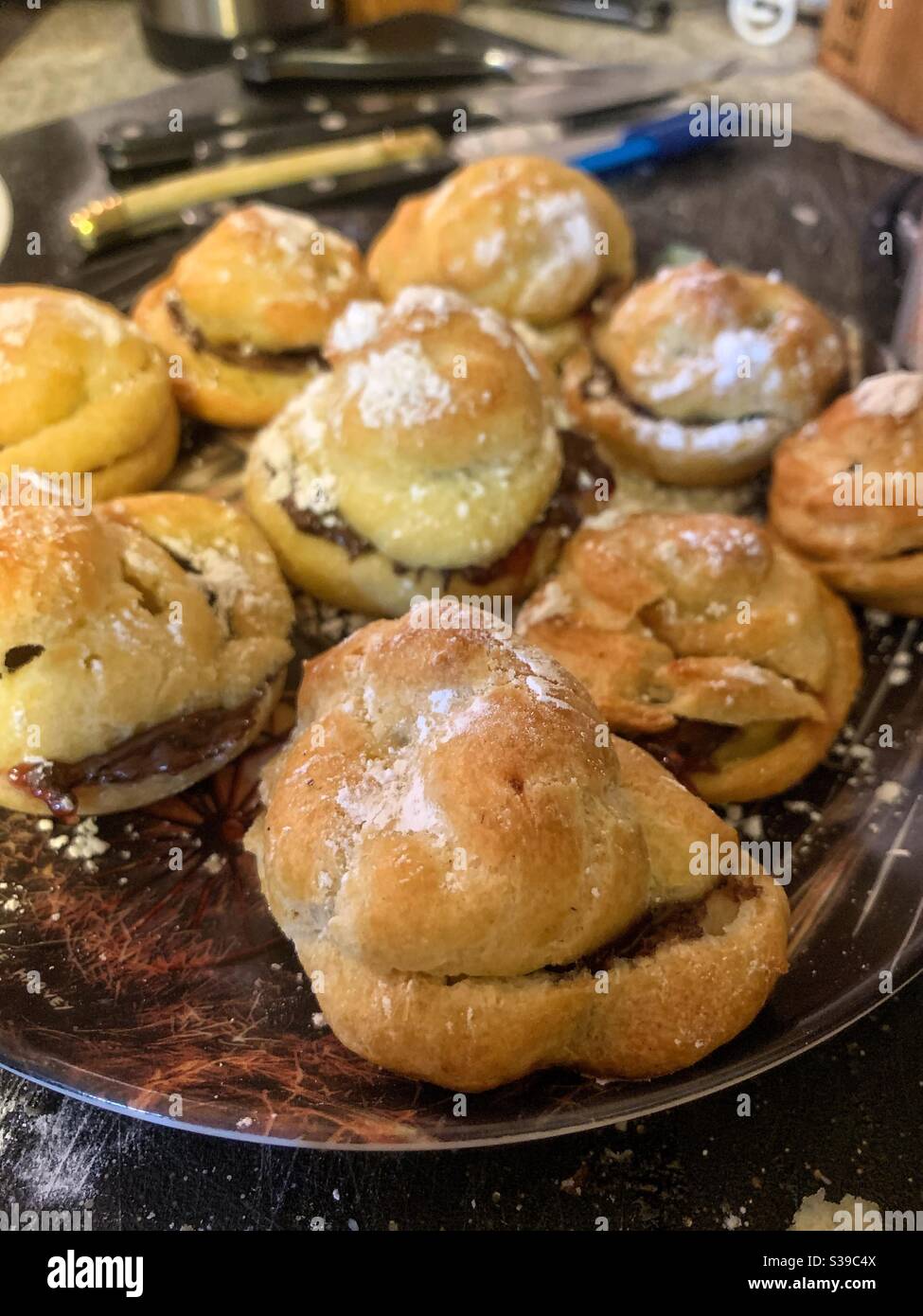 Delicious homemade chocolate cream puffs set on a tray and ready to eat ...