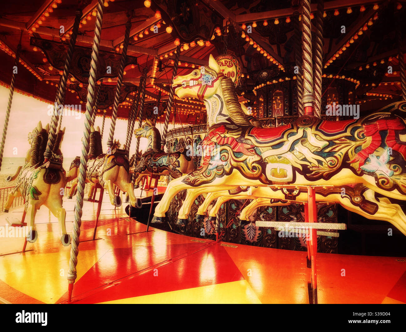 A carousel of horses await some riders at a funfair somewhere in Europe ...