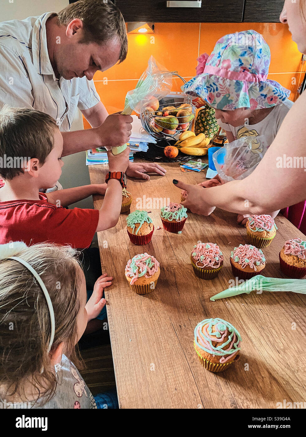 Children decorating cupcakes together hi-res stock photography and ...