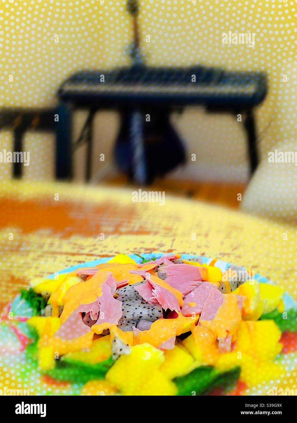 The homemade salade dish sits on the yellowish and depainted dining ...