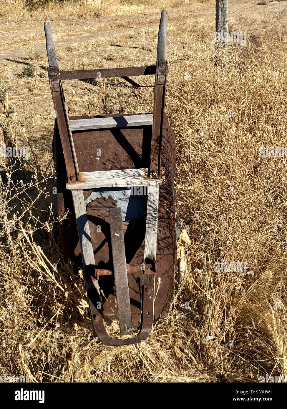 Rusted wheelbarrow hi-res stock photography and images - Alamy