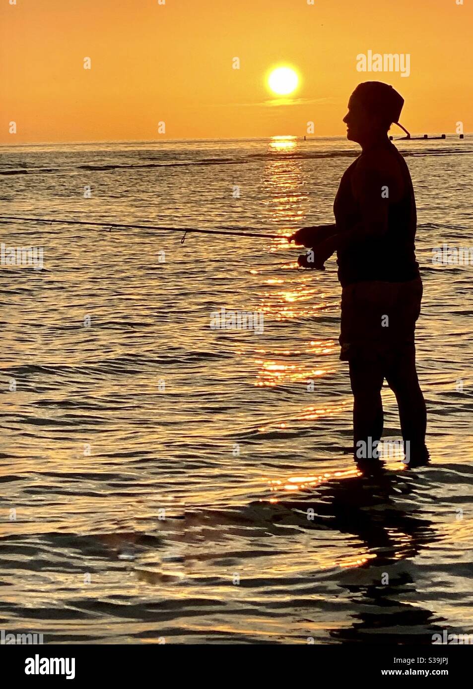 Surf fishing at Sunset on Honeymoon Beach Florida Stock Photo - Alamy