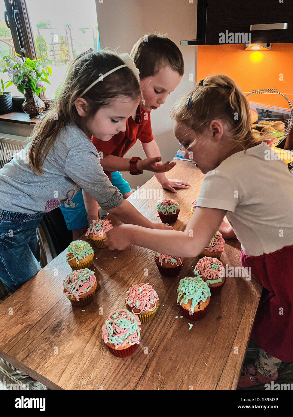 Group of children baking cupcakes, preparing ingredients, topping ...