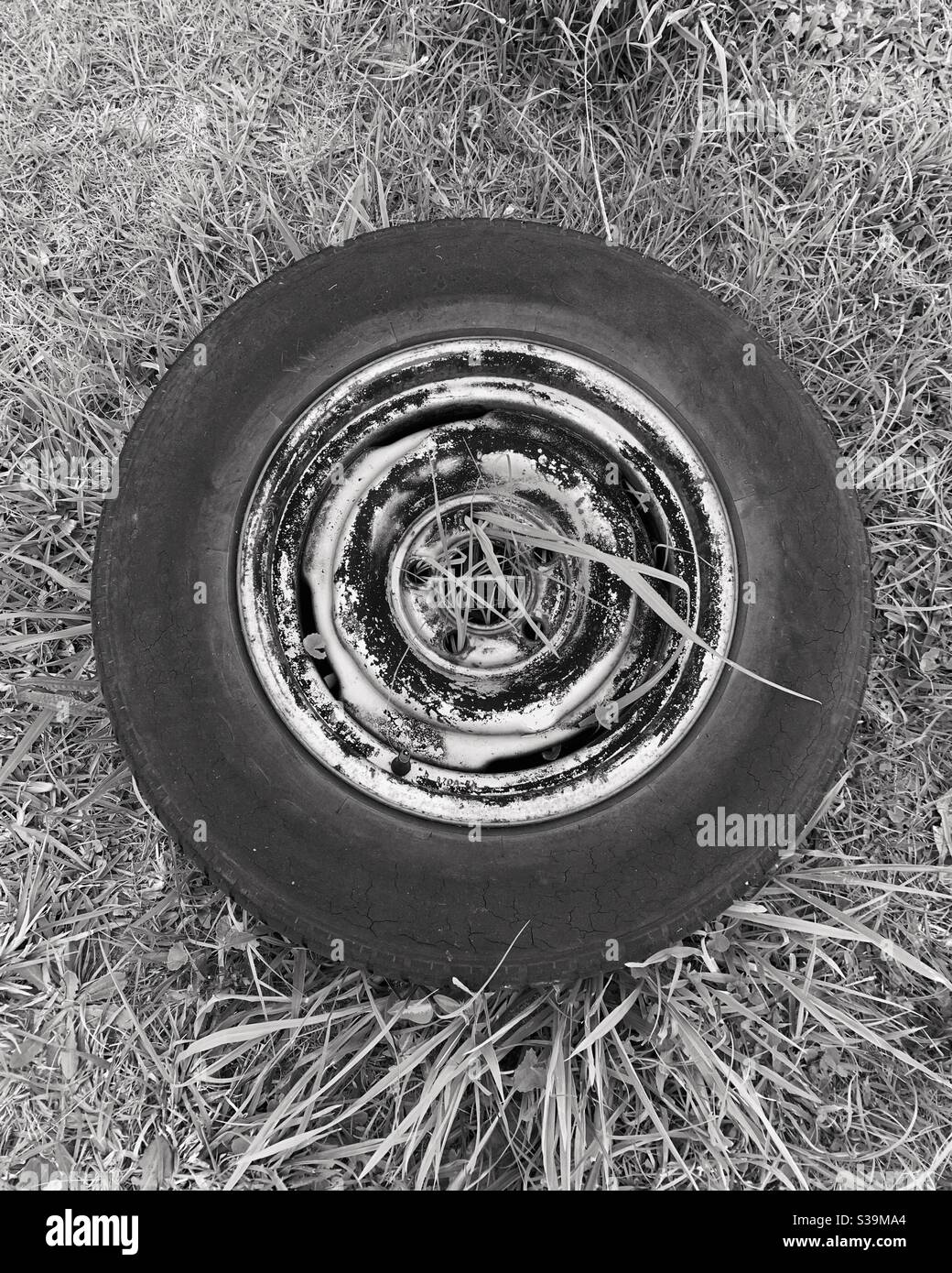 Black and white, of car wheel lying on the ground Stock Photo - Alamy