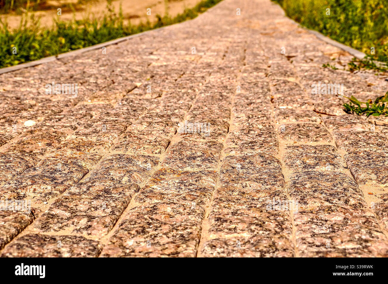 Stone road stretching into the distance Stock Photo - Alamy