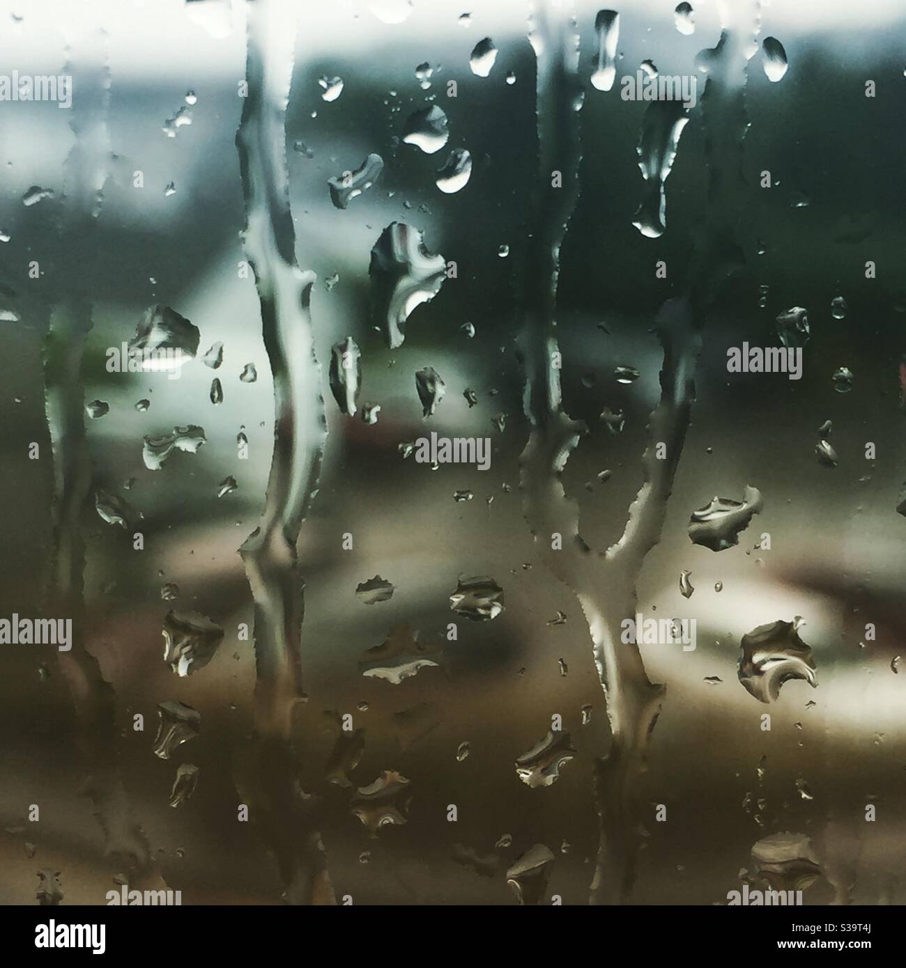 Rainwater running down window on a winter day Stock Photo - Alamy