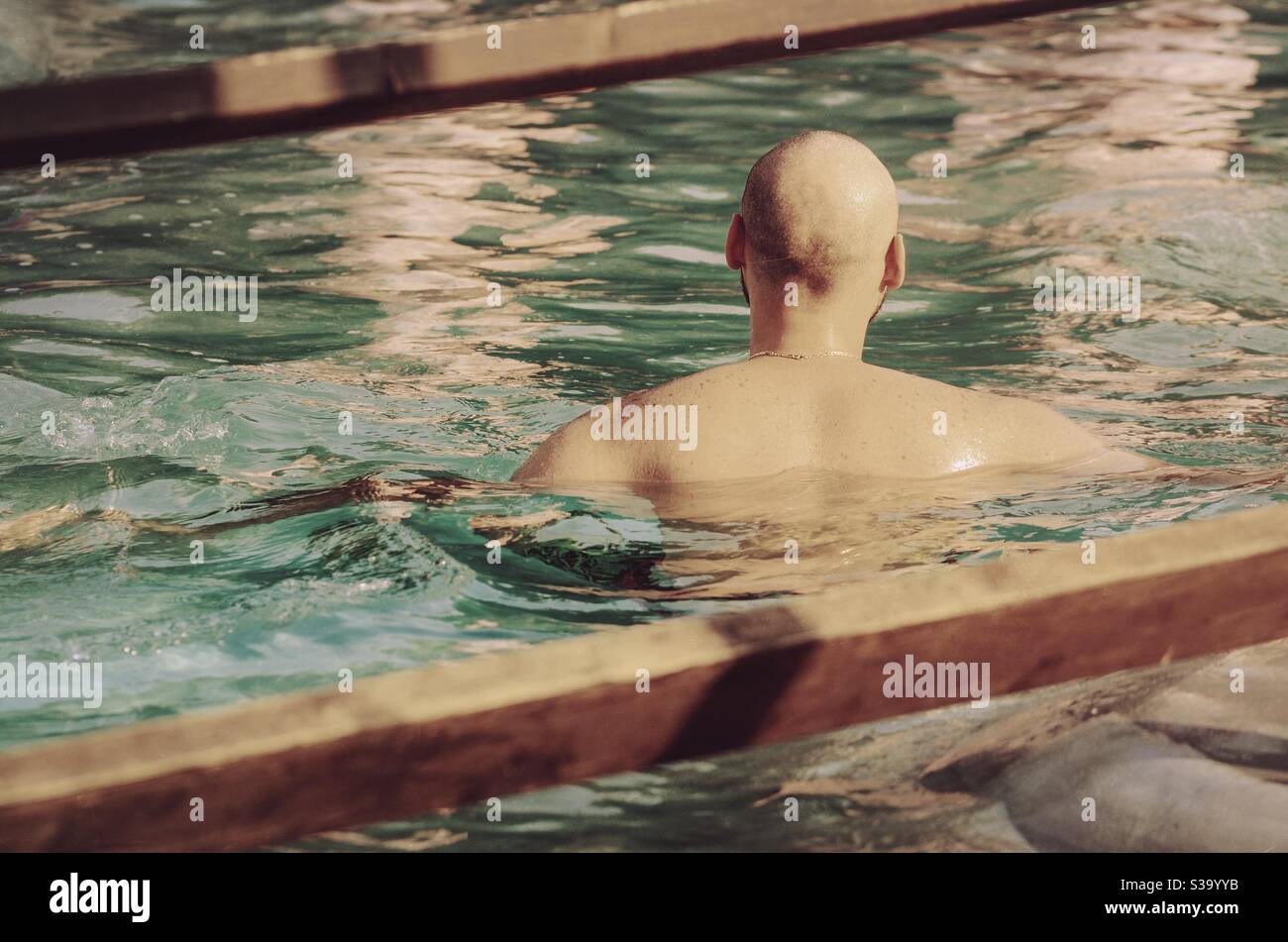 Bald man on a pool from back Stock Photo - Alamy