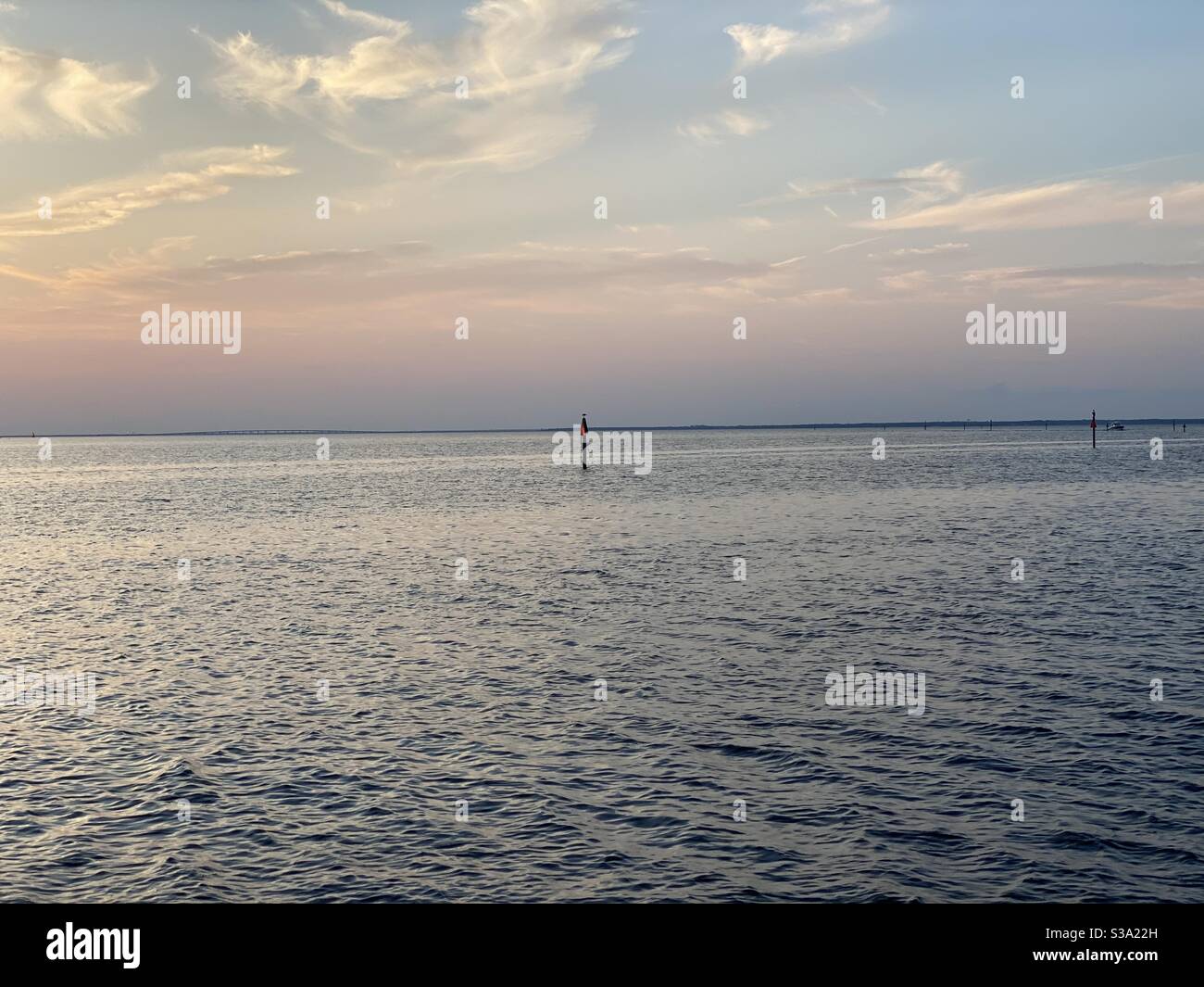 Soft pastel sunset skies over bay water Stock Photo - Alamy