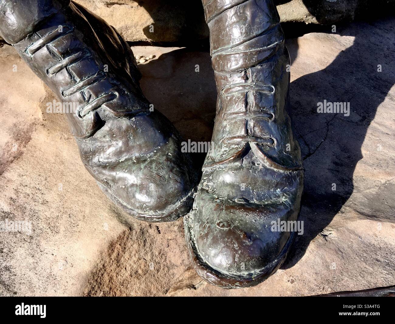 Bronze boots of statue Stock Photo - Alamy