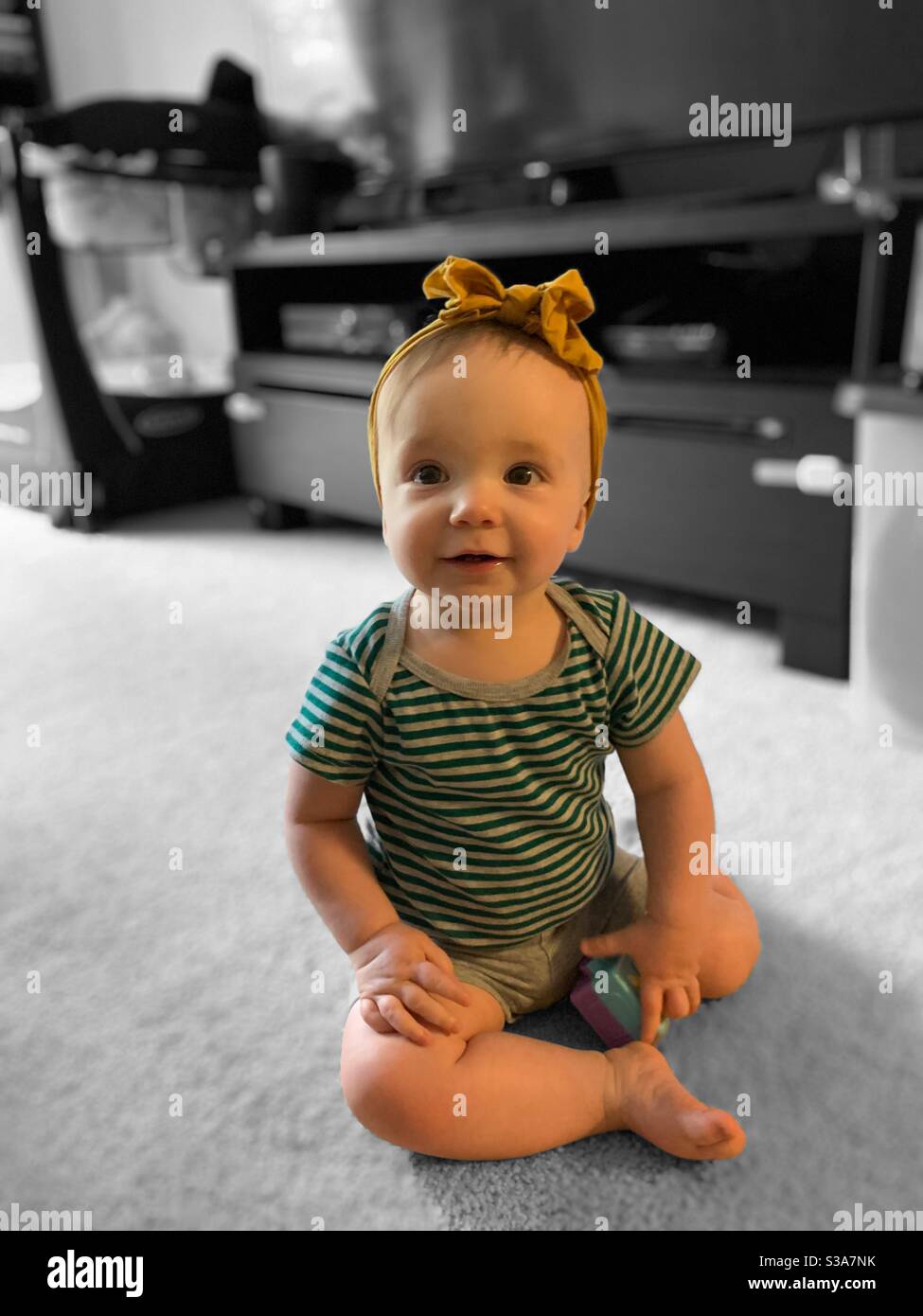 Baby sitting, black and white background Stock Photo - Alamy