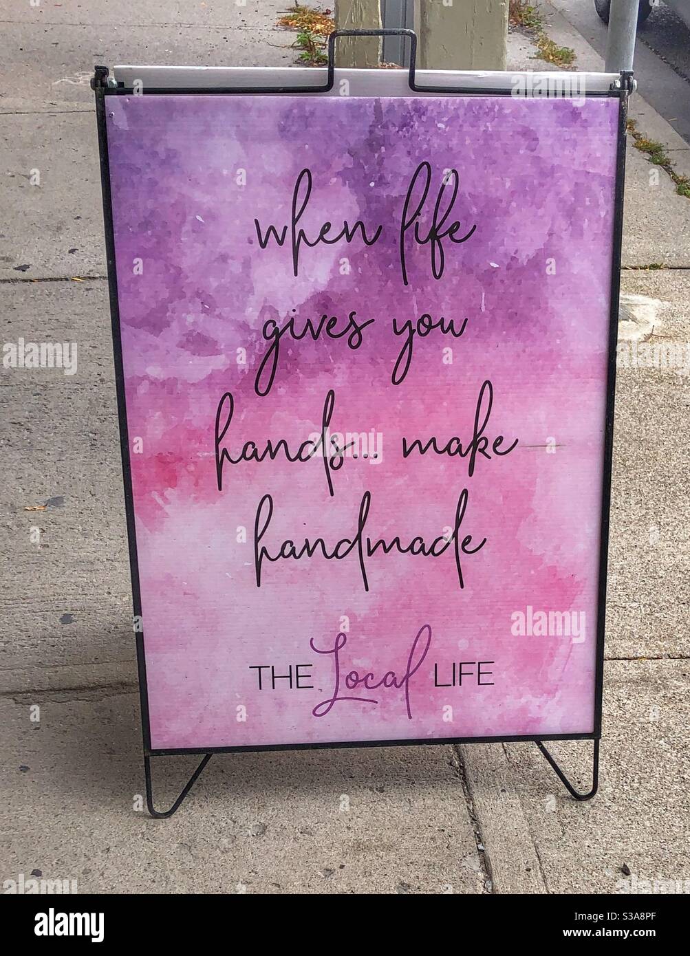 Inspirational quote in front of a shop Stock Photo - Alamy