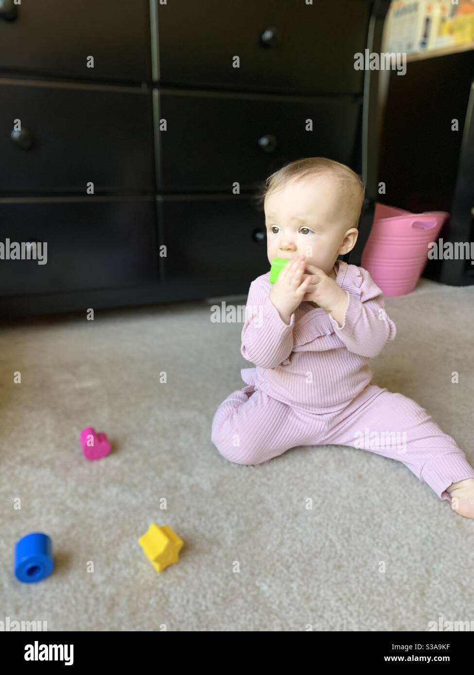 Baby chewing a block hi-res stock photography and images - Alamy