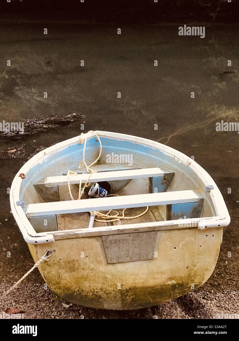 yellow dinghy aground in Pill Creek Stock Photo - Alamy