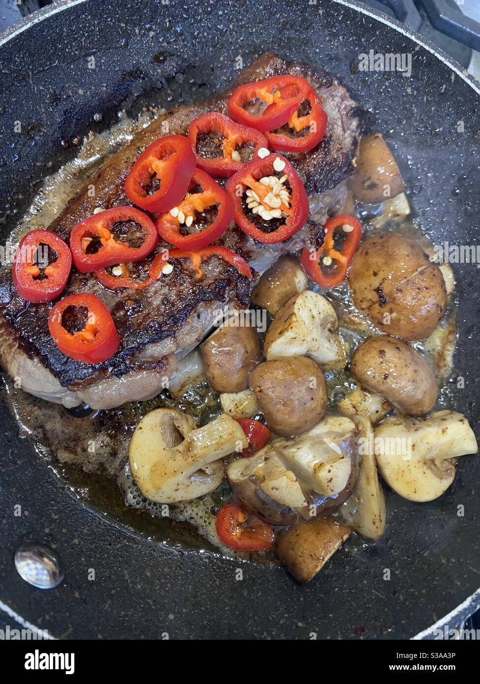 Rump Steak, Red Chilli, Mushroom Butter and herb sizzler Stock Photo ...