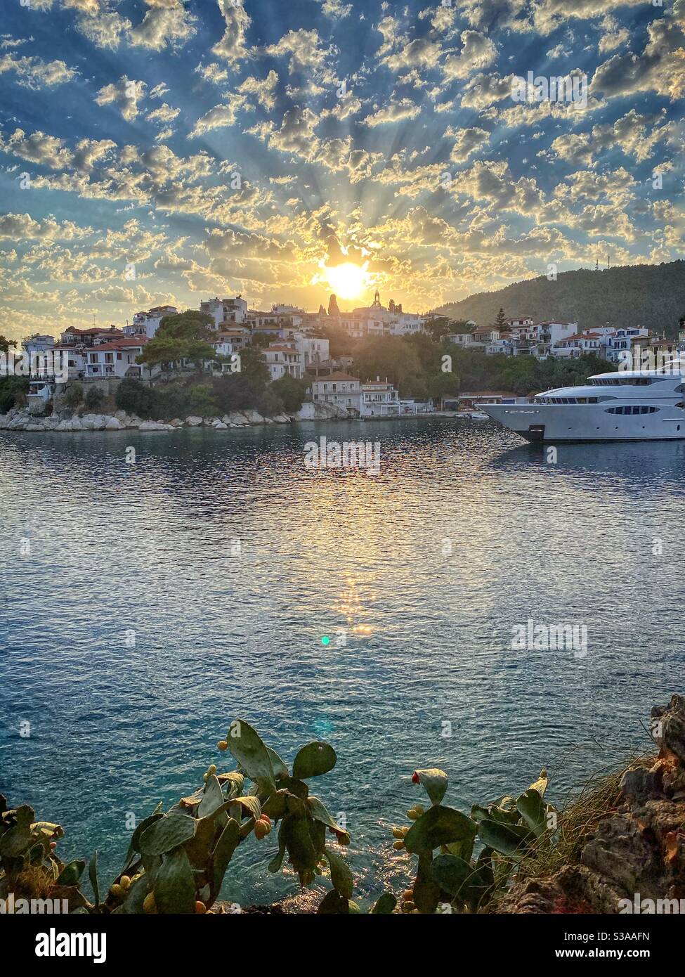 Sunset sea view with boat at Skiathos town from Bourtzi peninsula Stock ...