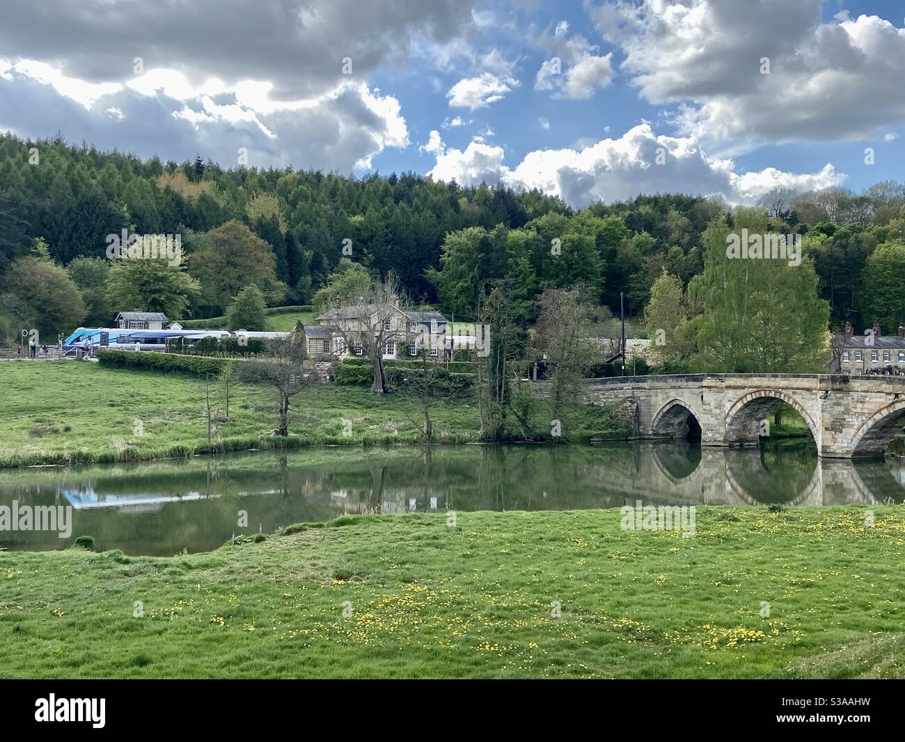 Bridge over River Derwent at Kirkham Abbey, train reflection in river ...