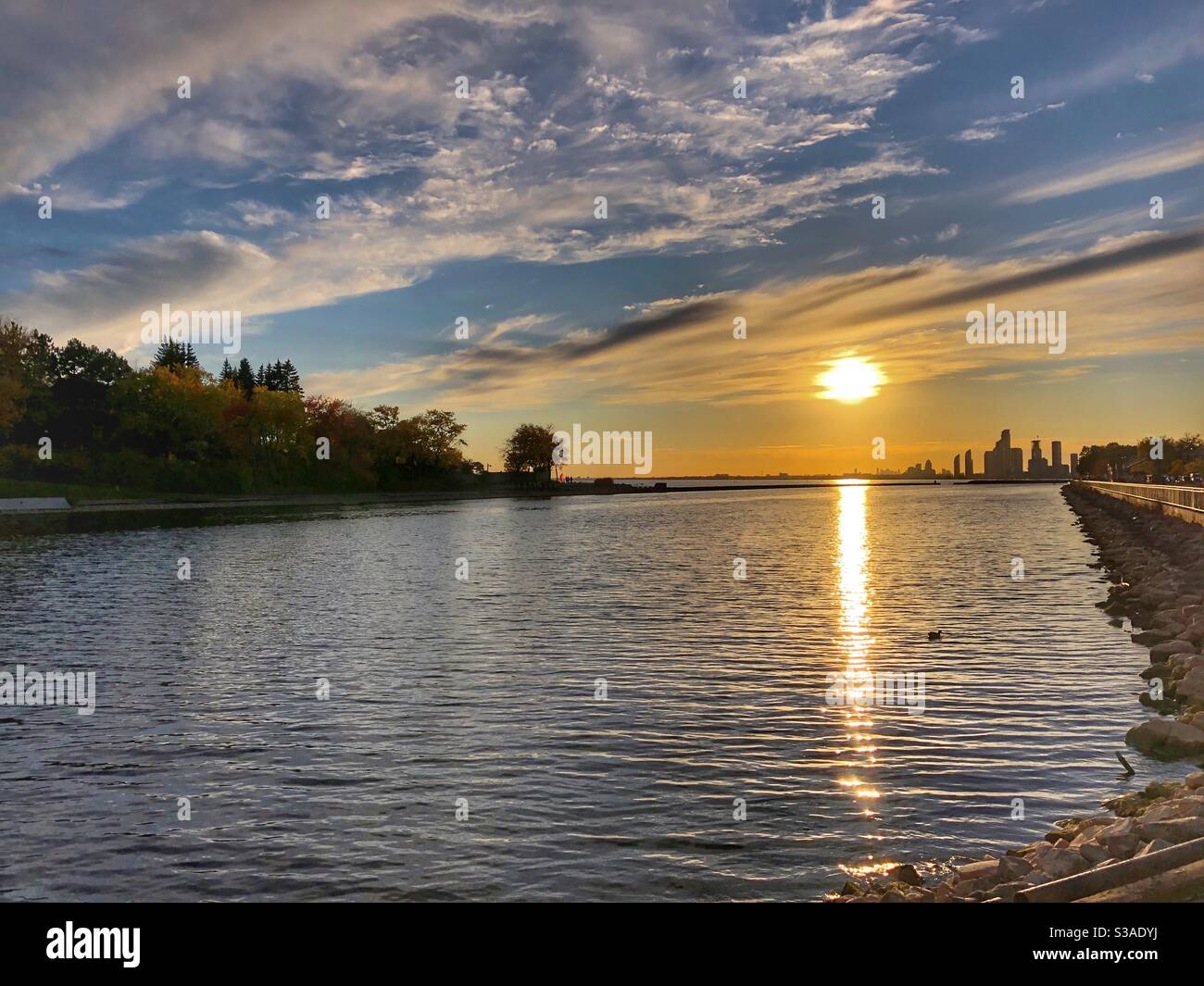 A glowing yellow sunset over Lake Ontario in Toronto Stock Photo - Alamy