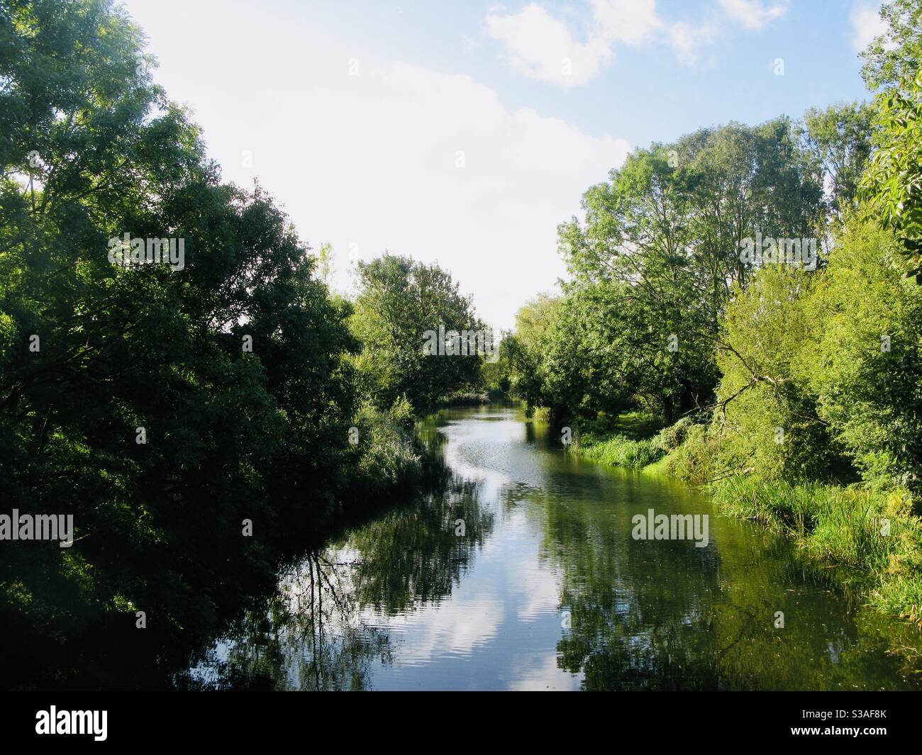 View down stream of the Great River Ouse with the sky reflecting on the ...