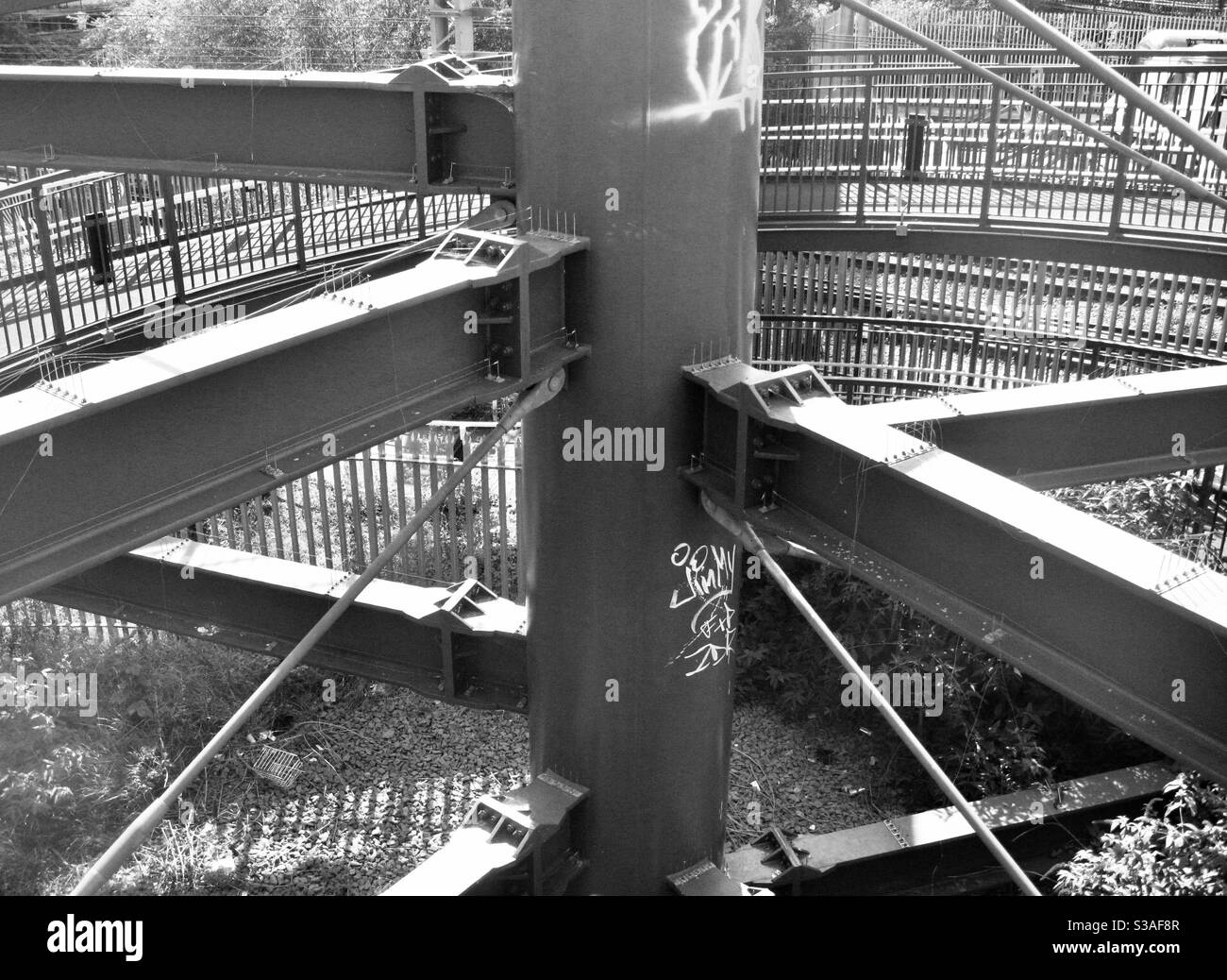 Metal spiral ramp with support beams with graffiti in grey scale Stock ...