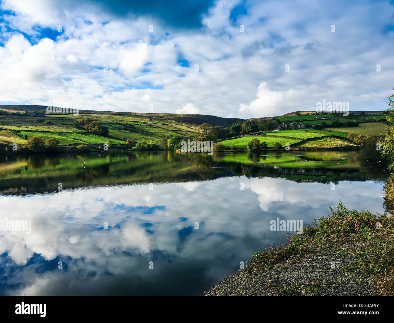 Reflection on a reservoir near Haworth in West Yorkshire on an autumn ...