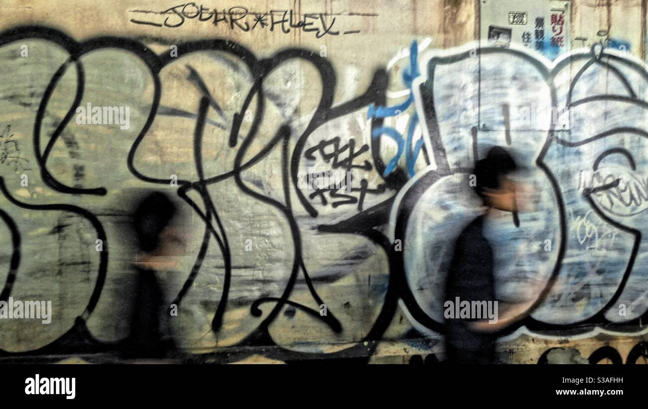 People walk by graffiti in Tokyo, Japan Stock Photo - Alamy