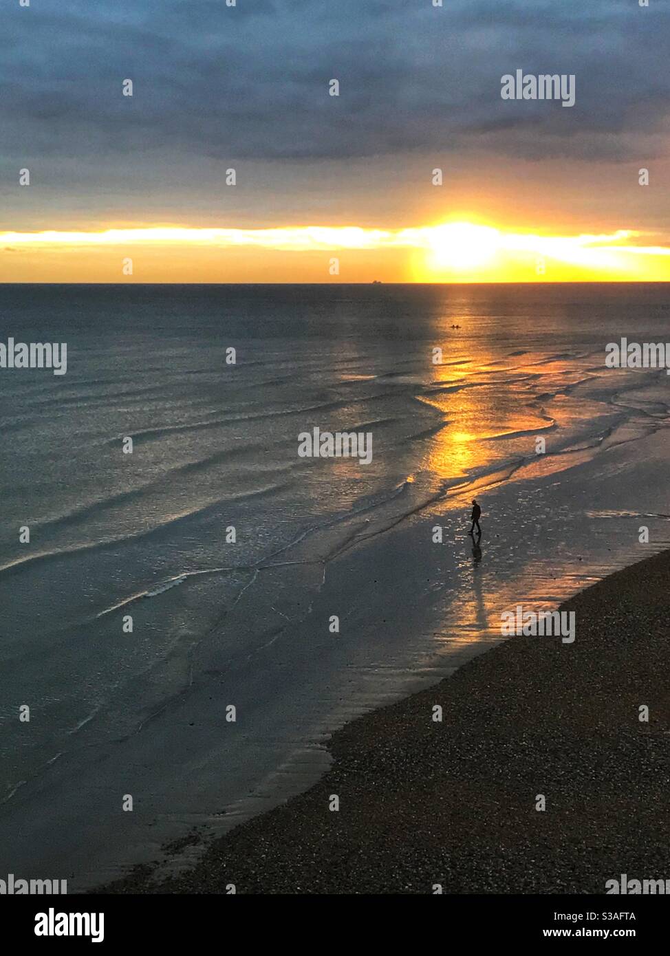 Sunset over Brighton beach Stock Photo - Alamy